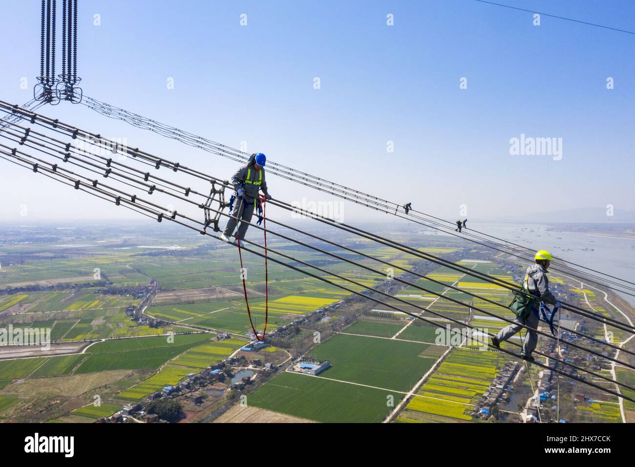 CHIZHOU, CHINA - MARCH 10, 2022 - Power maintenance workers work on a ...
