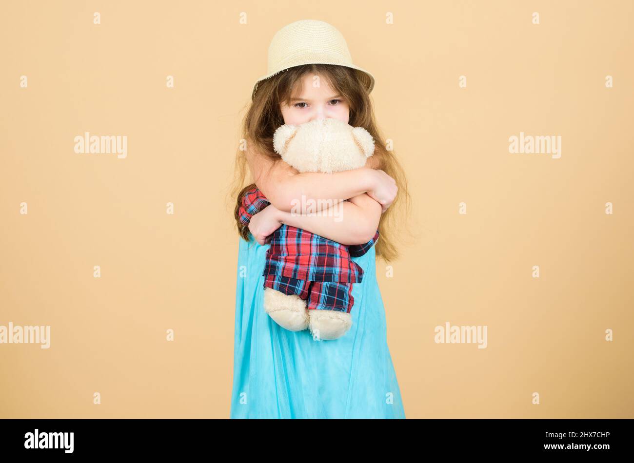 Toy is used in play. Adorable girl child with cute stuffed animal doll ...