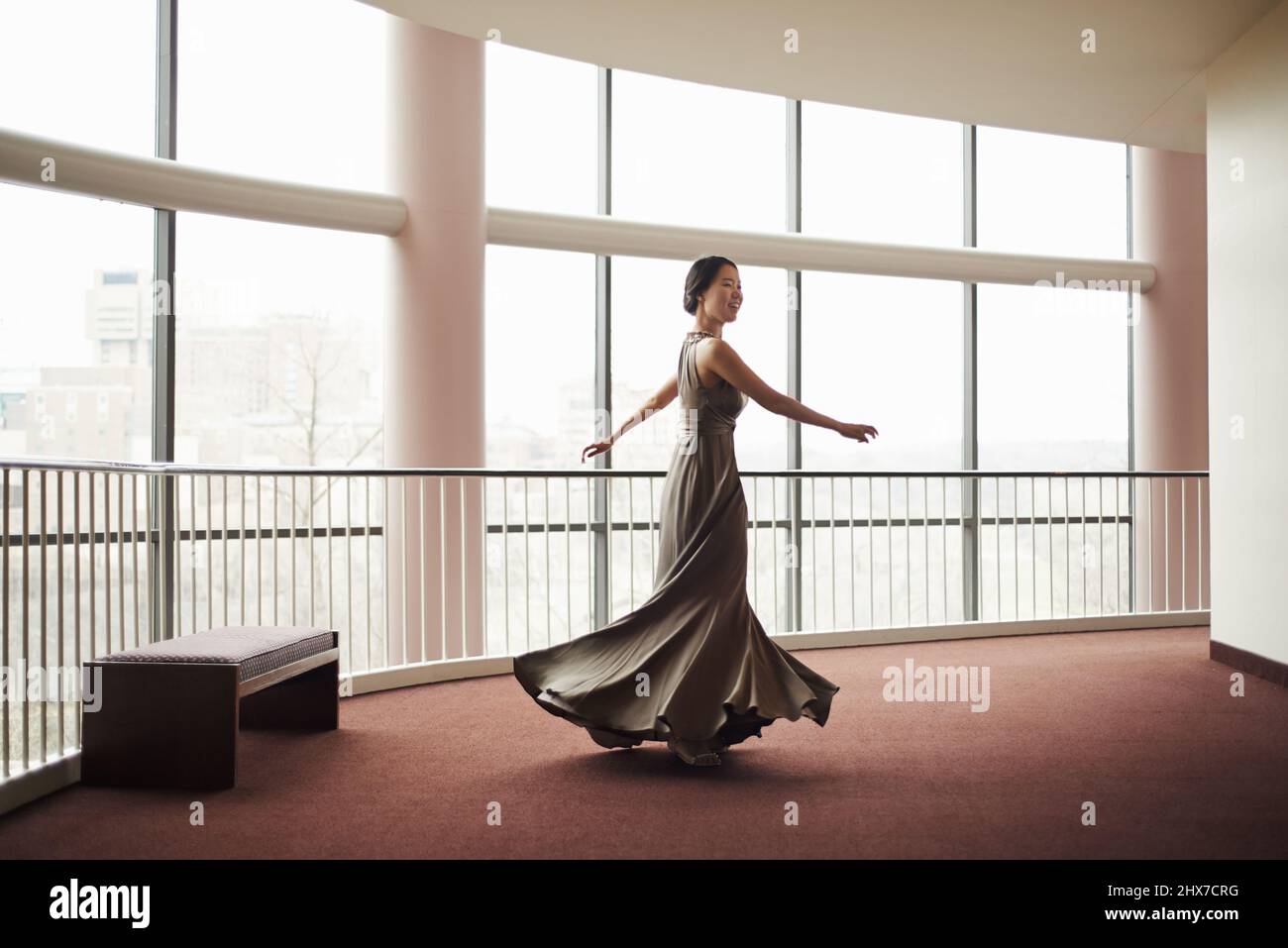 Graceful and carefree. Shot of an elegantly dressed young woman dancing ...