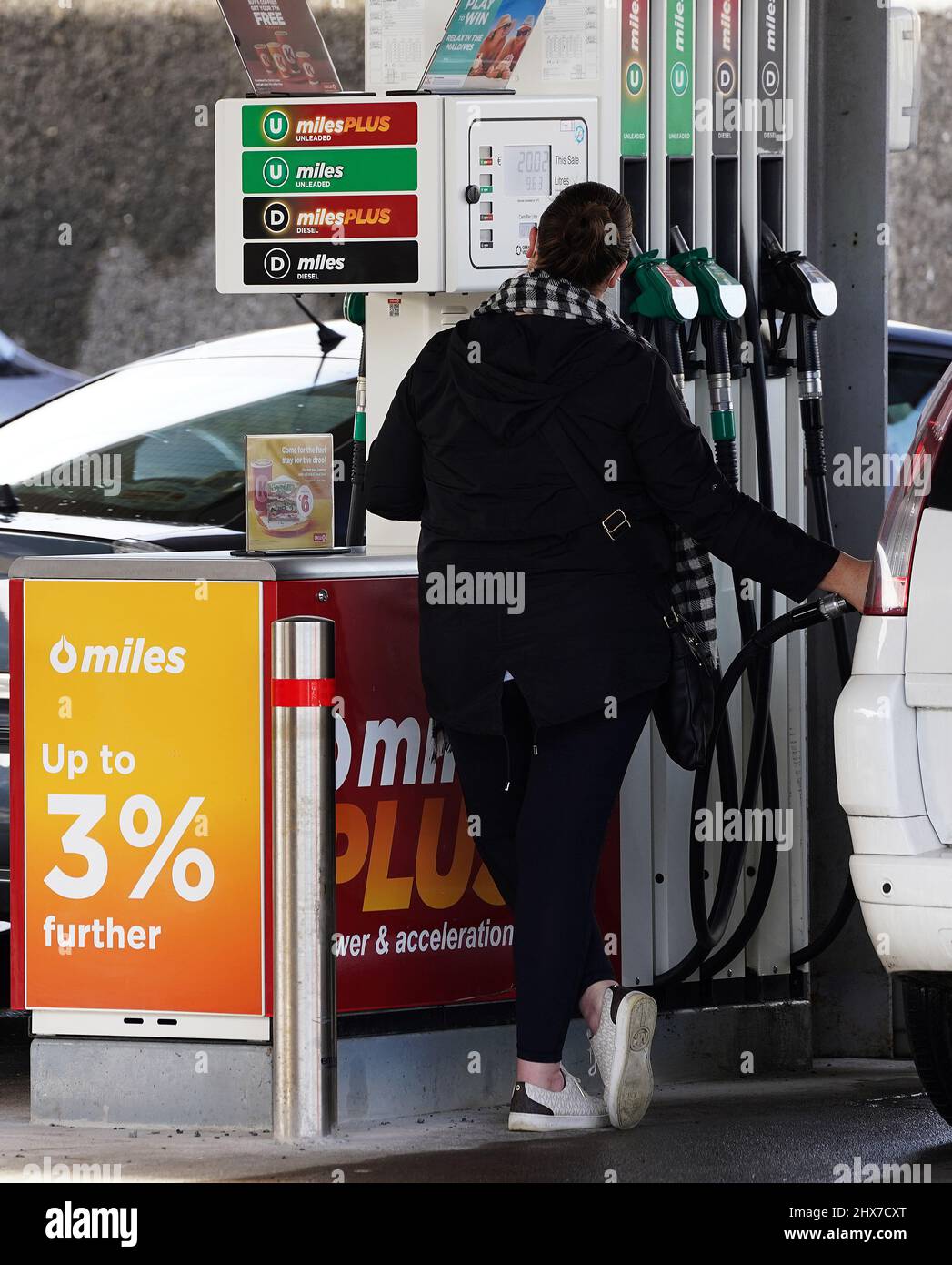 A woman at a fuel pump in a Circle K service station on Glasnevin ...