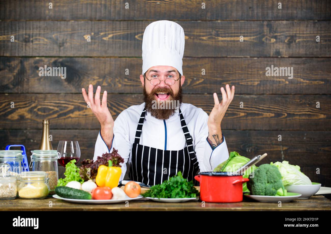 Happy bearded man cooking in kitchen. Dieting with organic food. Fresh ...