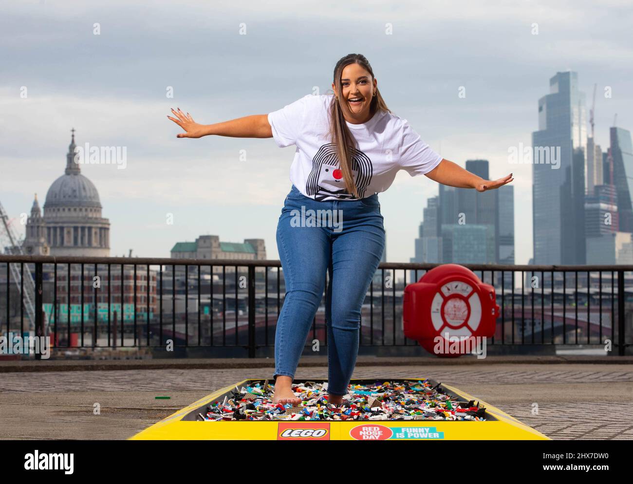 EDITORIAL USE ONLY Actor Jacqueline Jossa walks barefoot over a brick ...