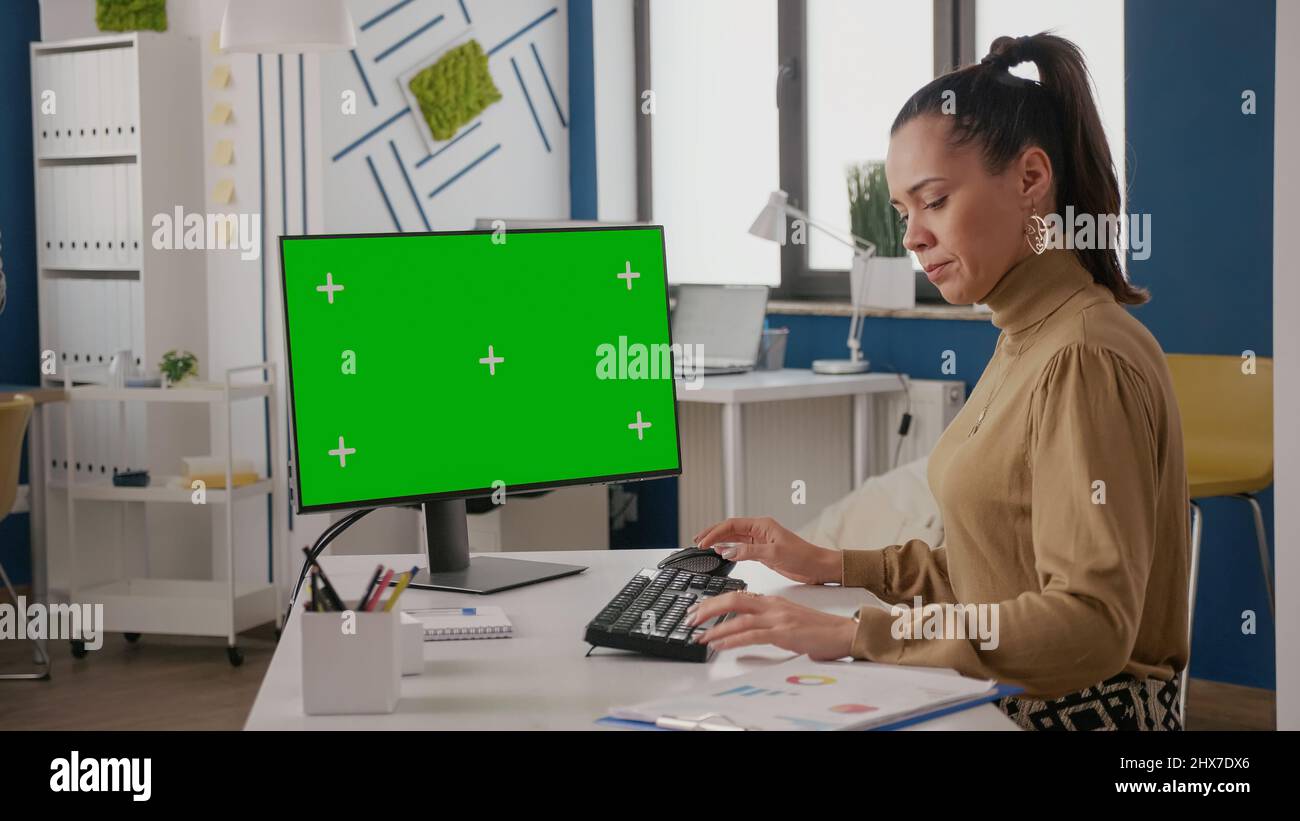 Close up of workmates talking and using green screen on monitor ...