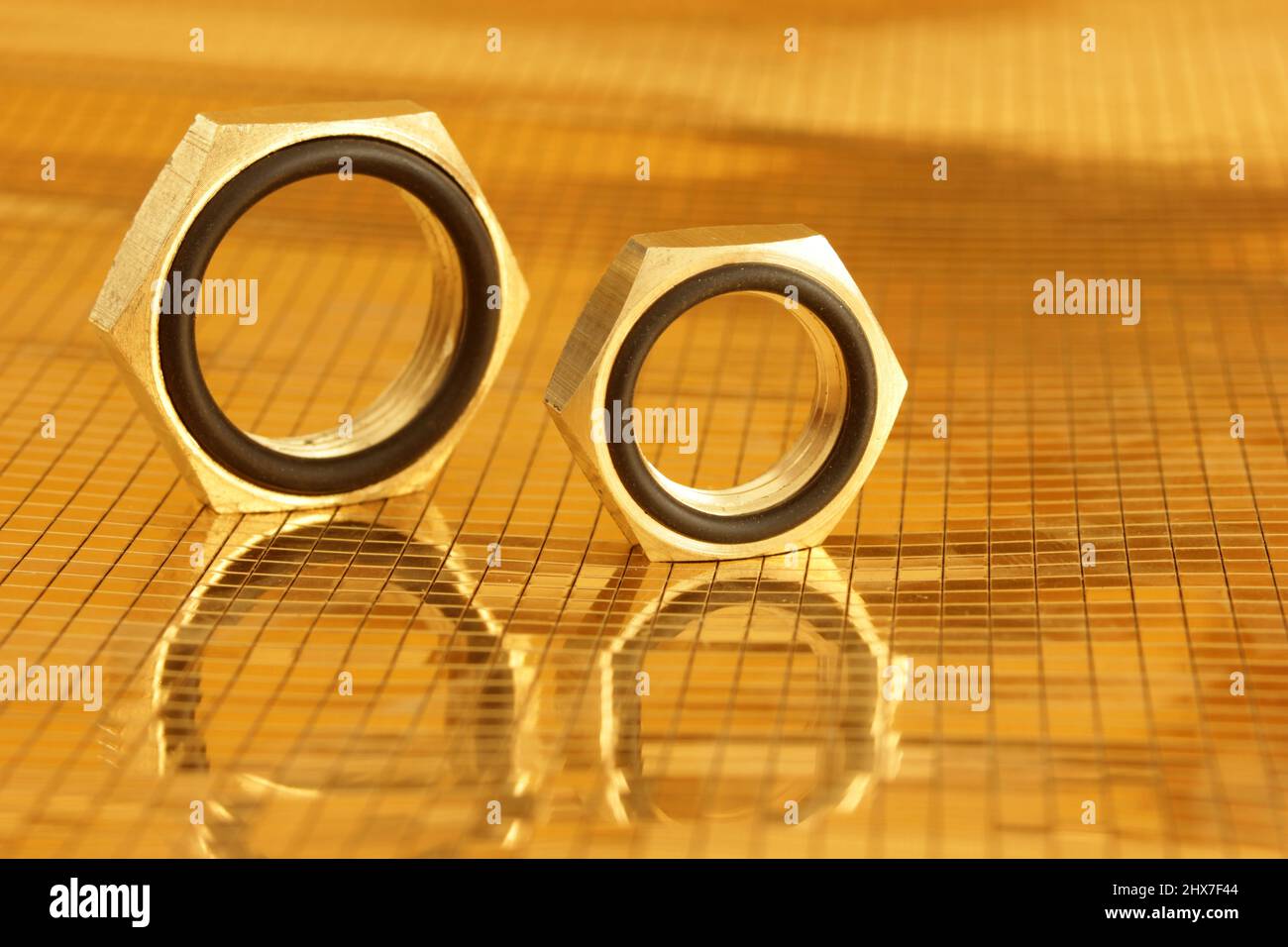 Sealing elements. Metal parts on yellow background Stock Photo - Alamy