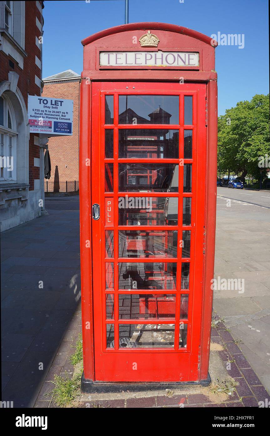 old red telephone box in the UK on a sunny day Stock Photo - Alamy