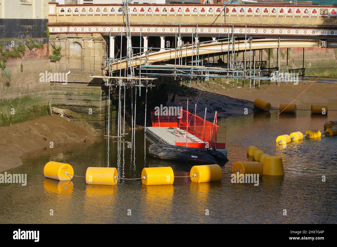 Maintenance is carried out on the old town bridge over the River Haven ...