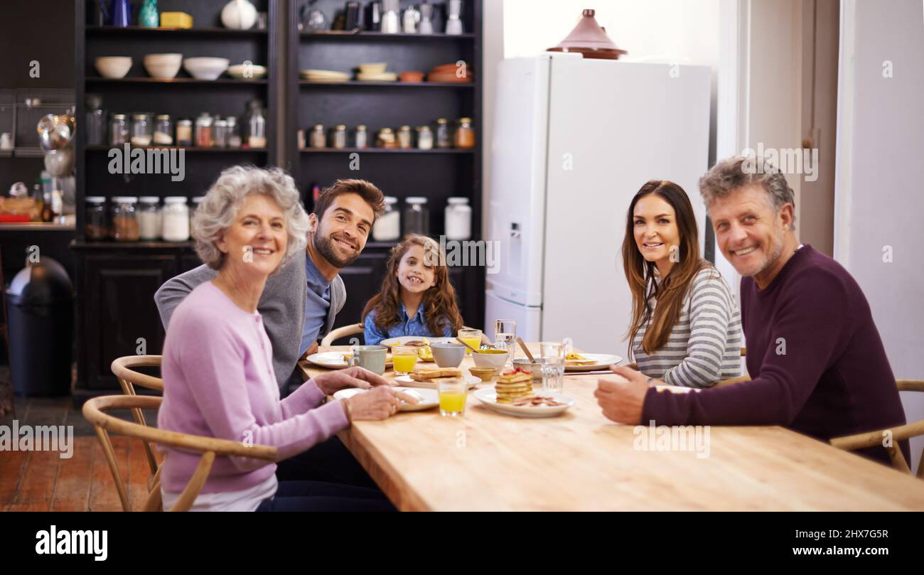 Starting the day with loved ones. Portrait of a family eating breakfast ...