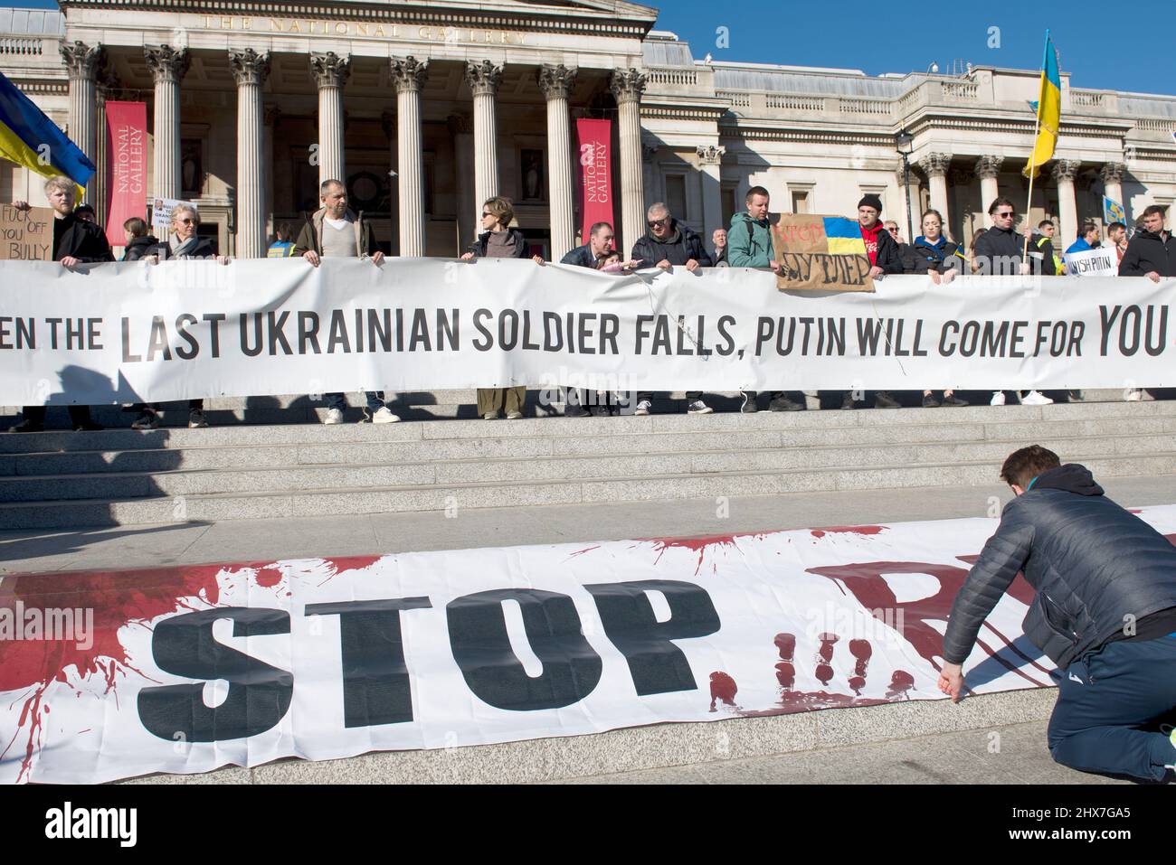 A group of protesters with banners and slogans at a solidarity rally in ...
