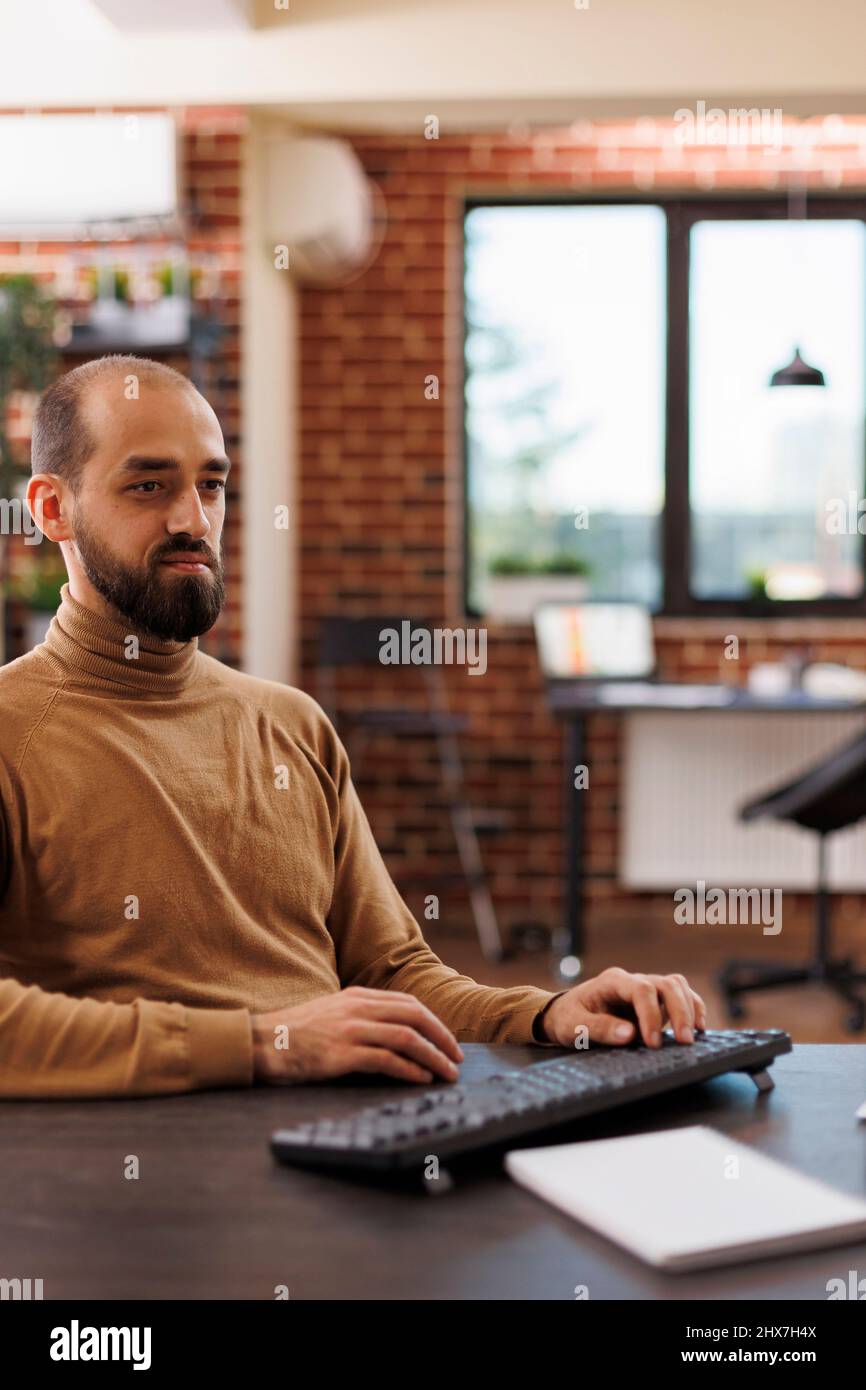 Financial company CEO sitting at desk in office workspace while ...