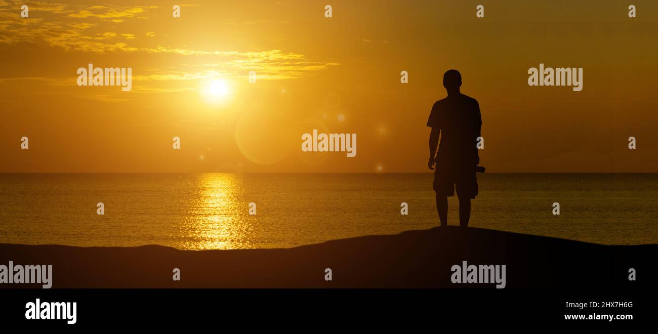 A panoramic view of a man silhouette holding a camera looking at a ...