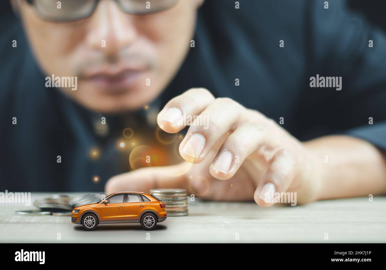 Asian men save money for cars. Men are using their hands to grab car ...