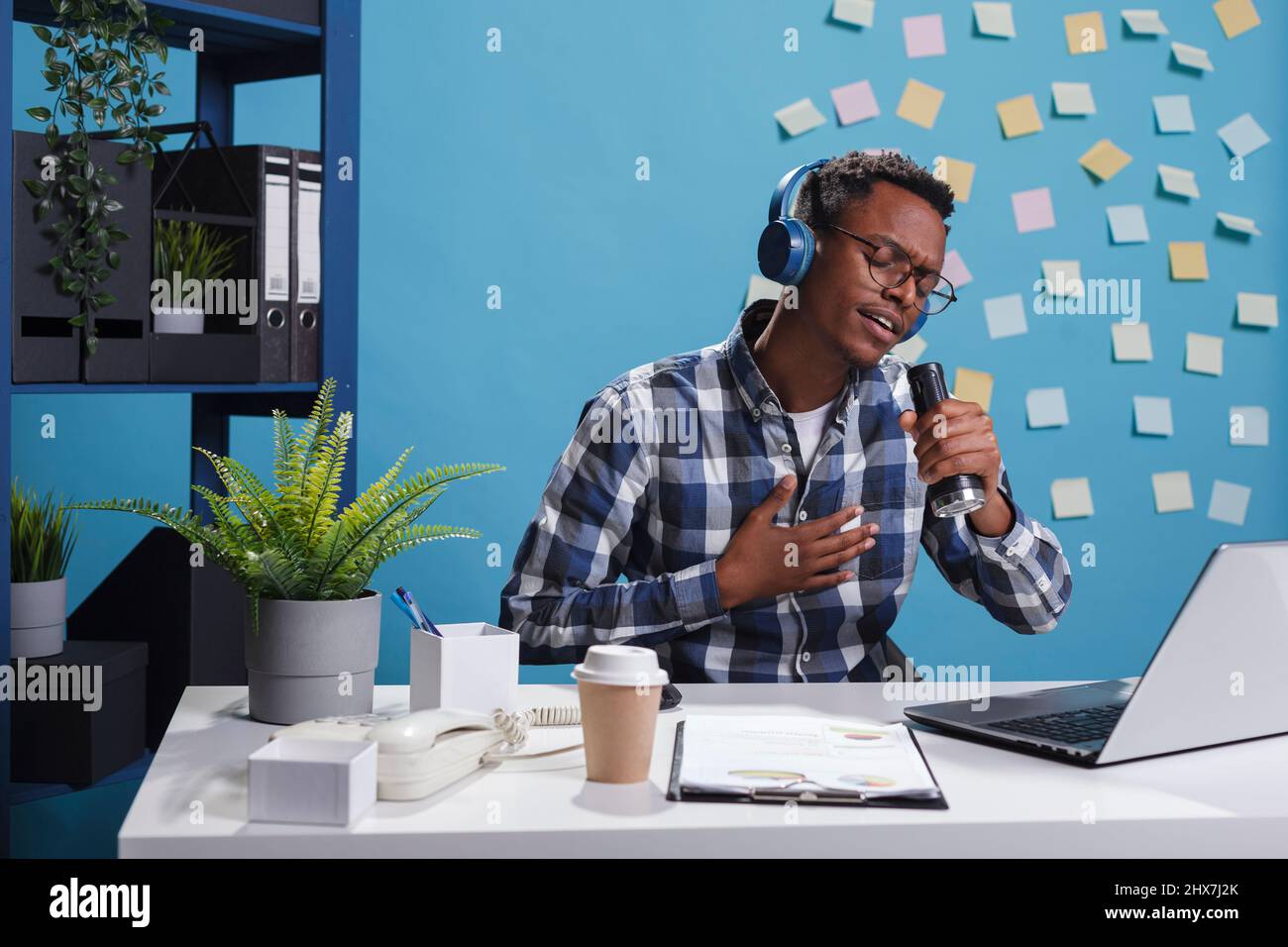 Business person in breaktime at work singing music while wearing audio ...