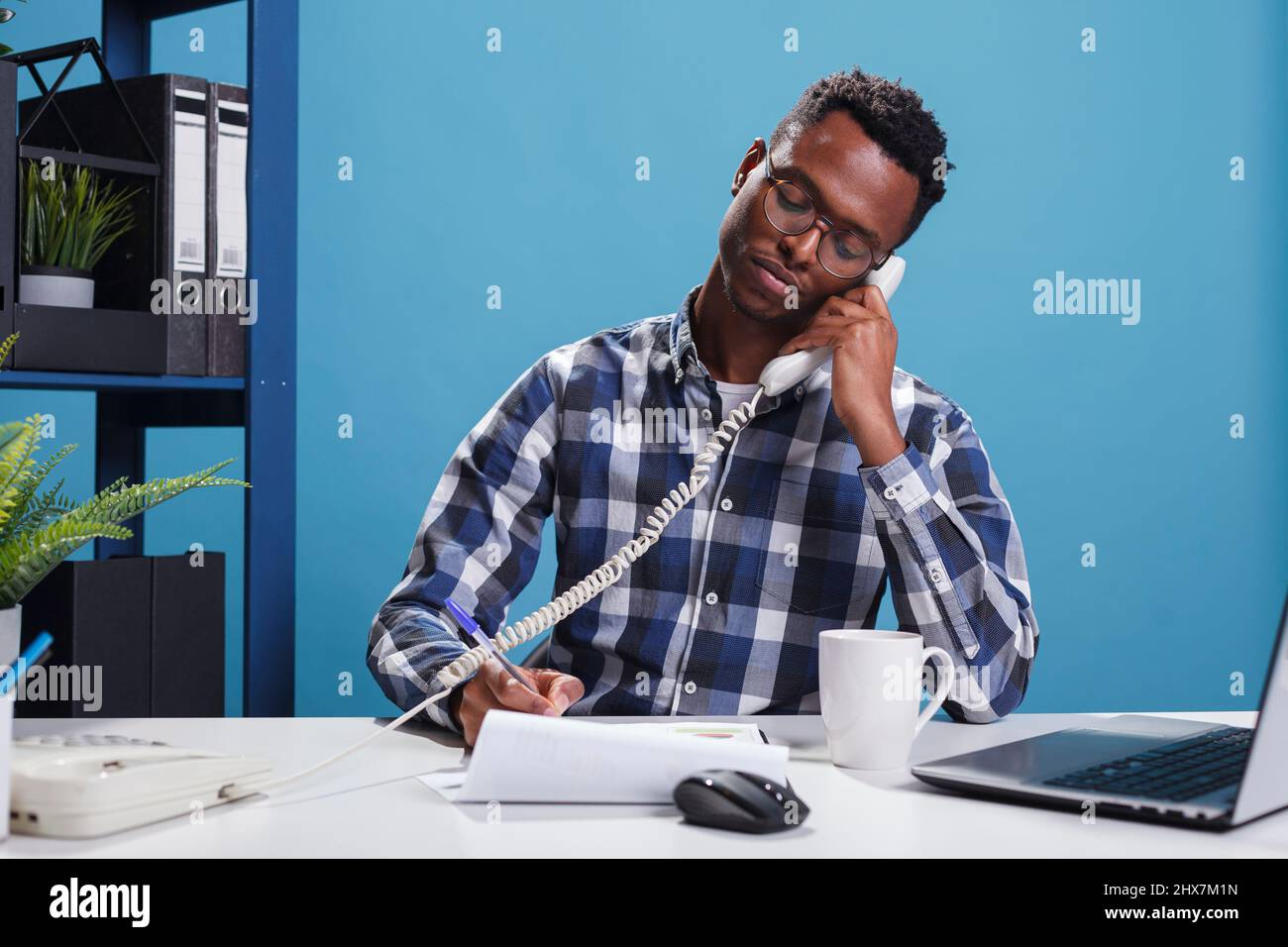 Serious confident company insurer on landline call with potential ...