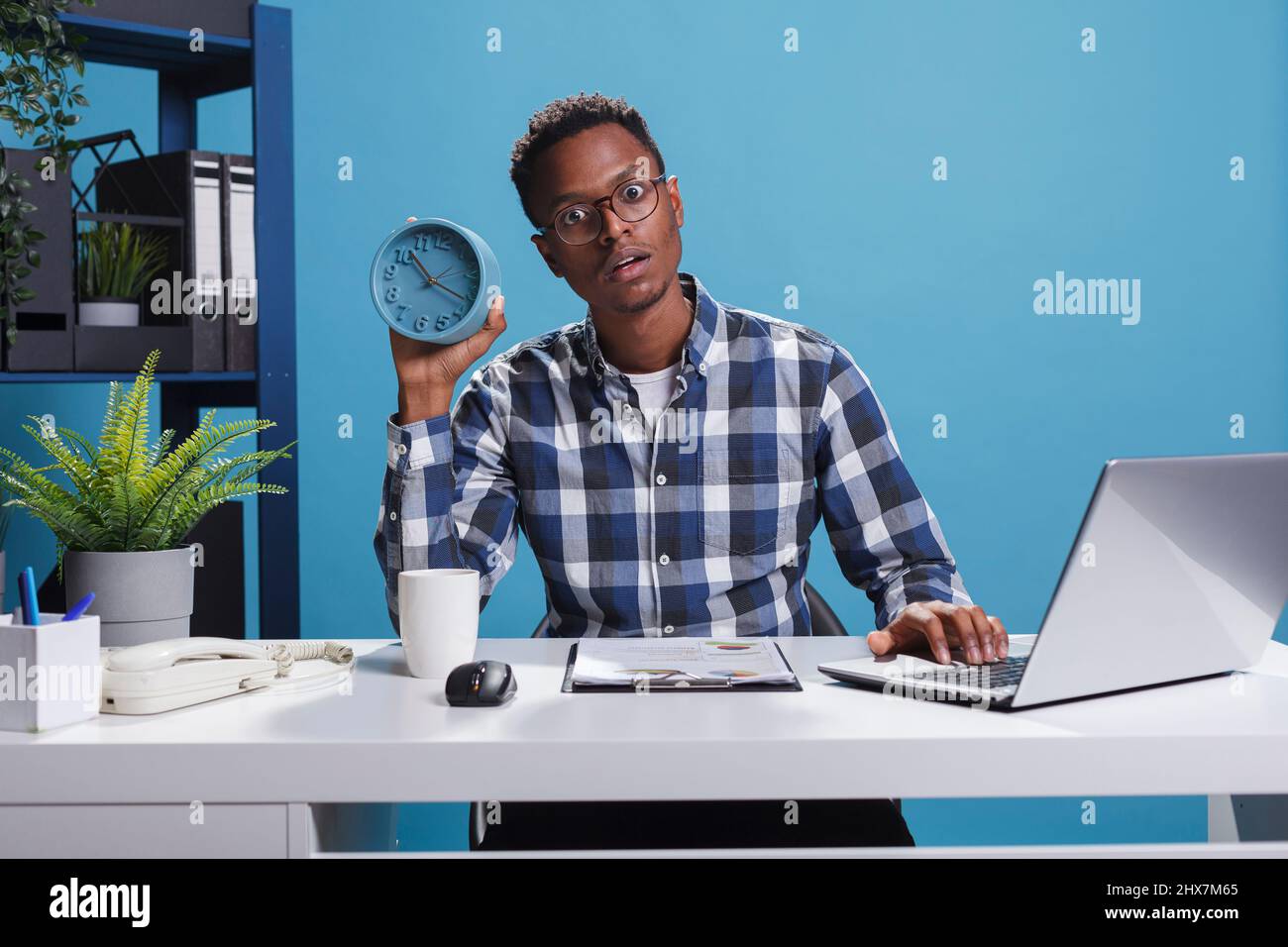 Company businessman with shock expression face having alarm clock while ...