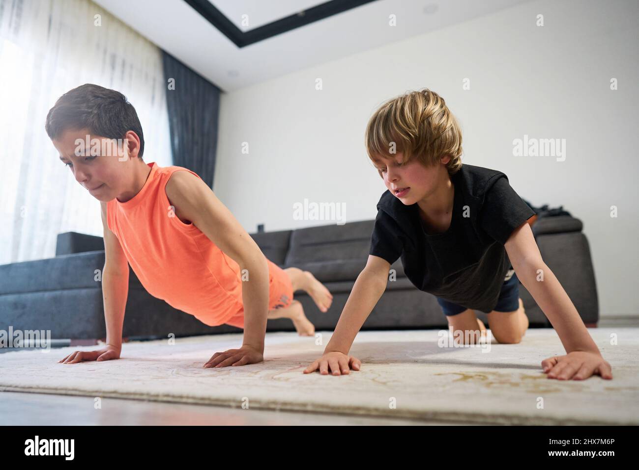 Two boys brothers play sports in the bright kitchen at home. Home ...