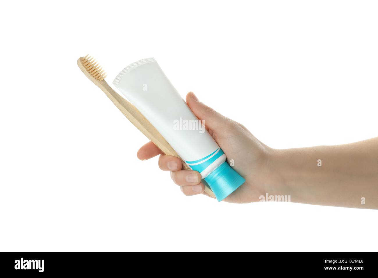 Female hand holds toothbrush and toothpaste, isolated on white ...