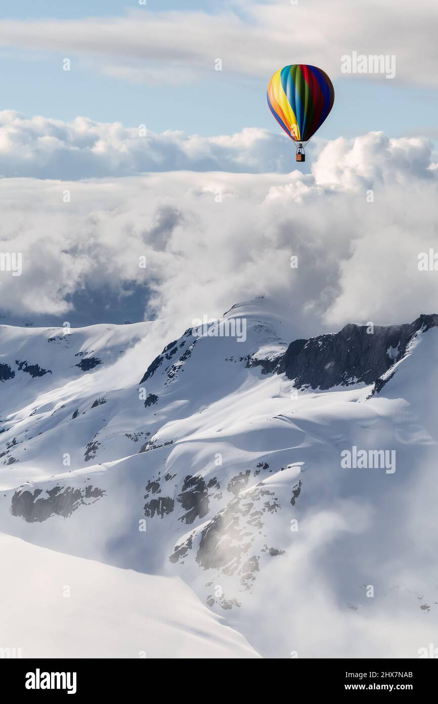 Dramatic Mountain Landscape covered in clouds and Hot Air Balloon ...