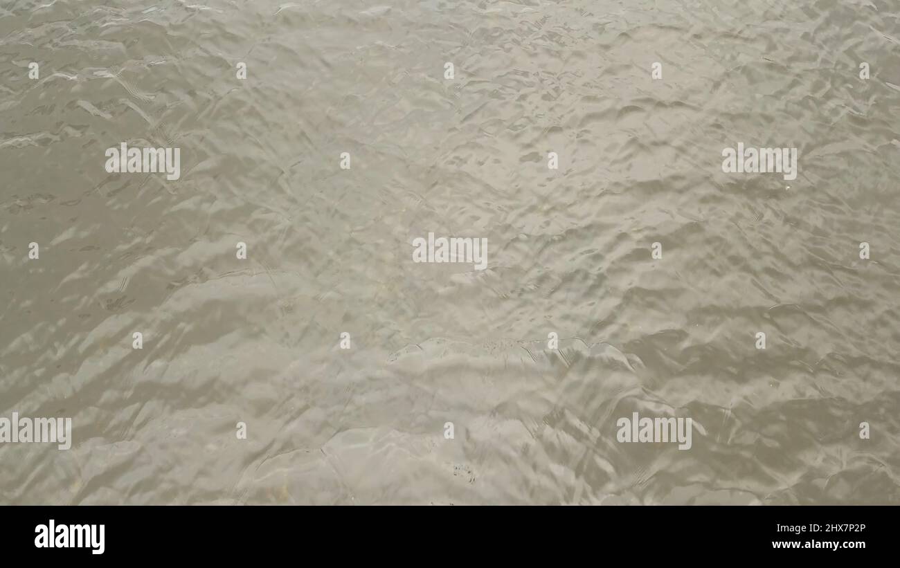 Water surface with ripples and sunrays reflection. Stock footage ...