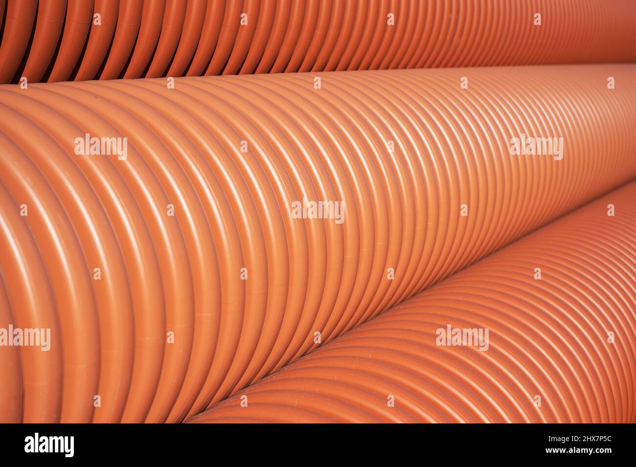 Close-up Stack of new orange polypropylene pipes. Plastic pipes for ...