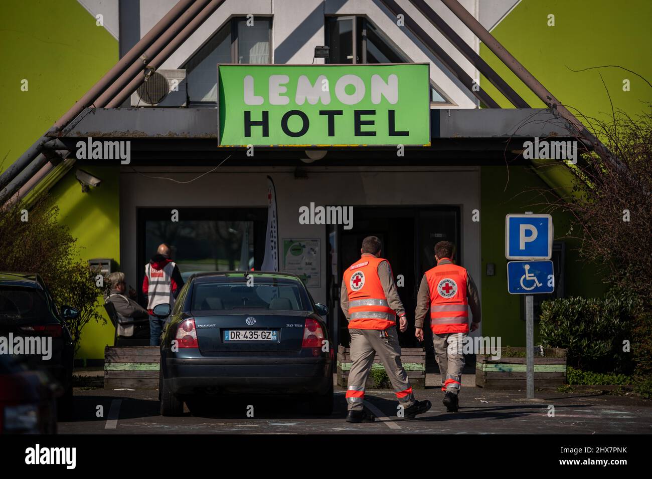 Members of the Red Cross enter a budget hotel being used to house ...