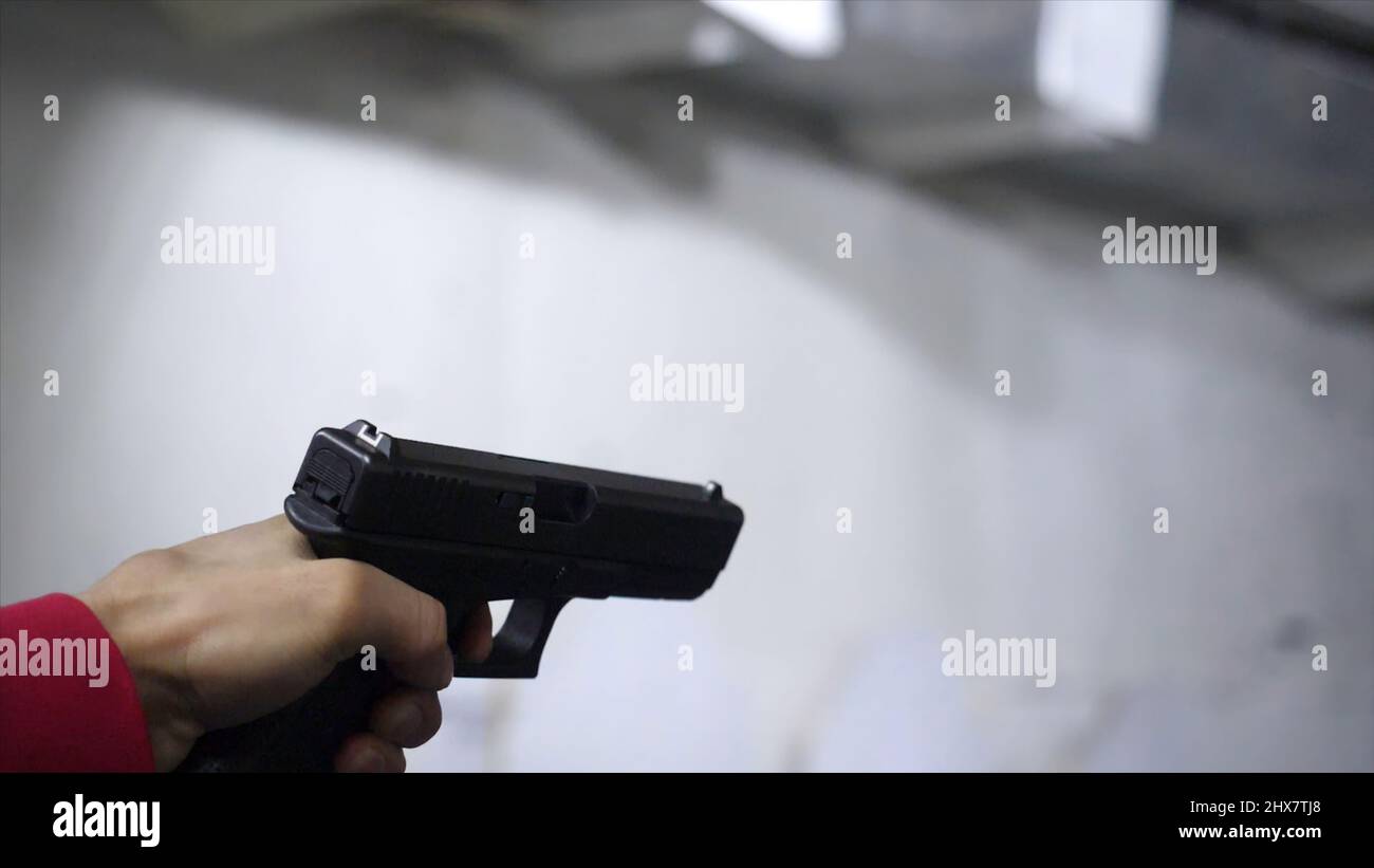 Gun in the man's hand. Man holding a gun close-up. Black handgun in ...