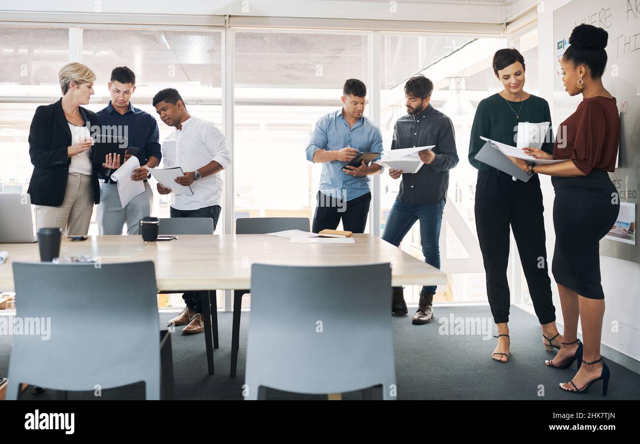 Get together and get it done. Shot of a group of businesspeople ...