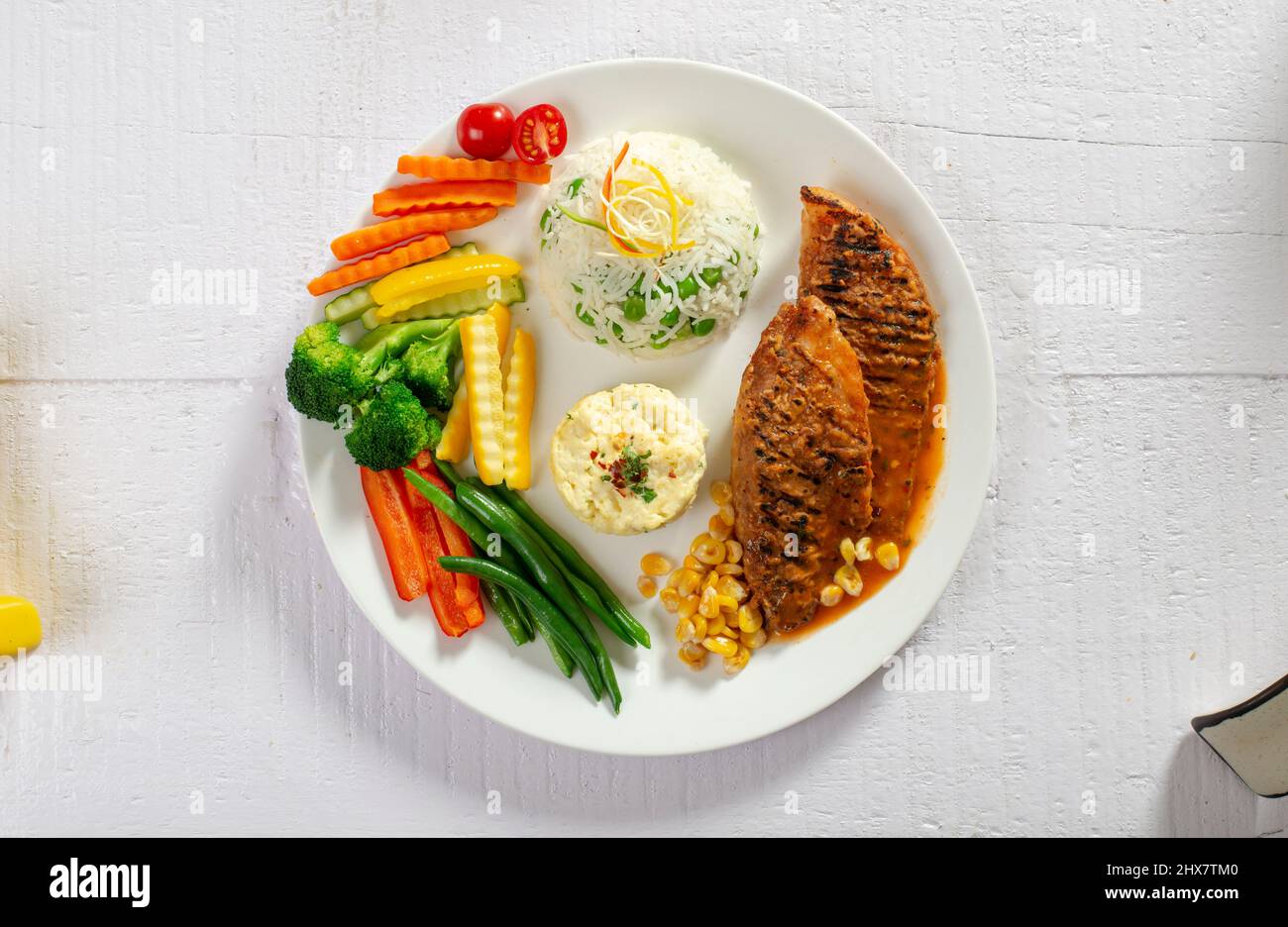 Grilled chicken/fish with rice & vegetables Stock Photo - Alamy