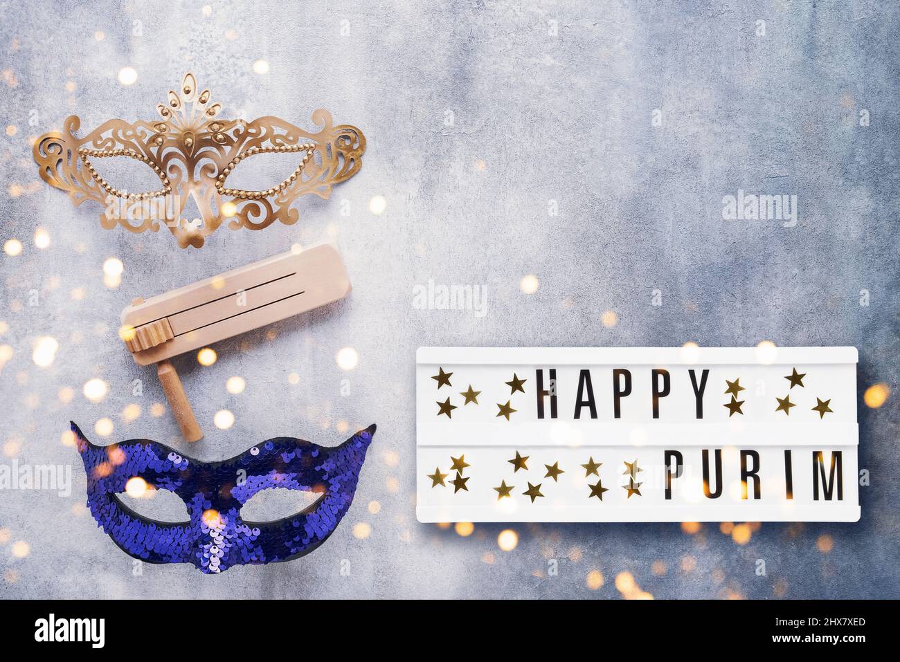 Flat lay of Purim Carnival celebration concept. Happy Purim written in ...