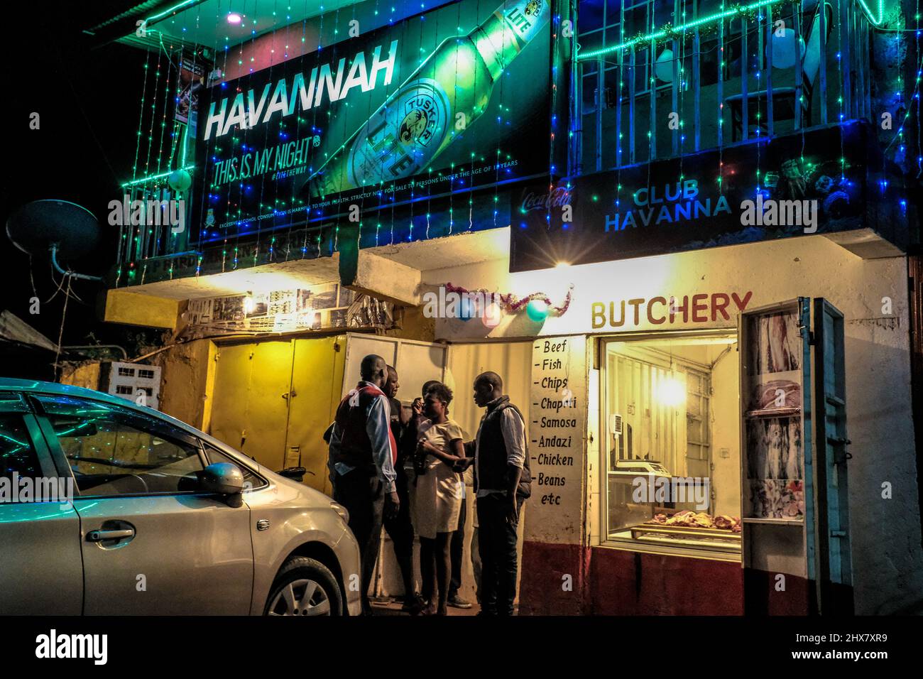 locals stand by a bar in Kibera Slums during new years eve on 1st ...