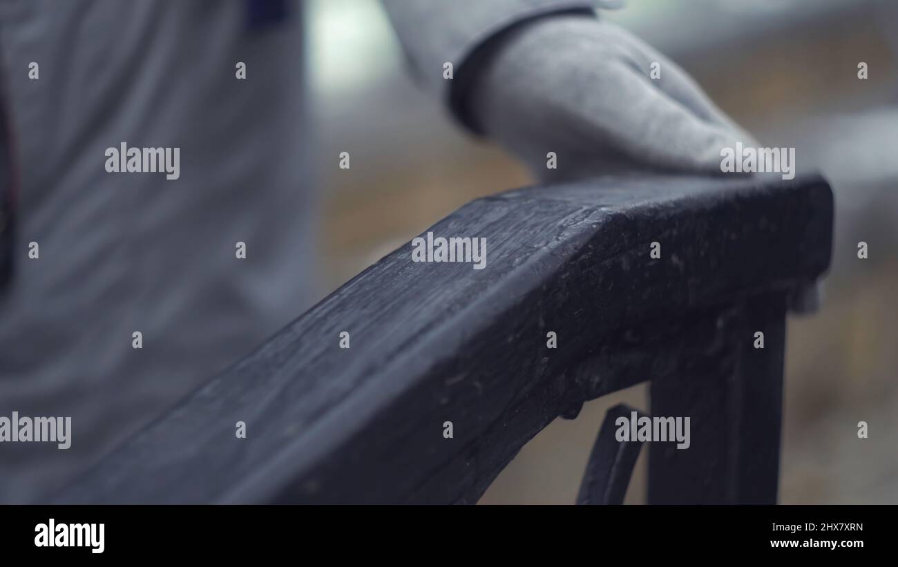 Close-up of young girl's hand sliding over railing. Hand in grey glove ...