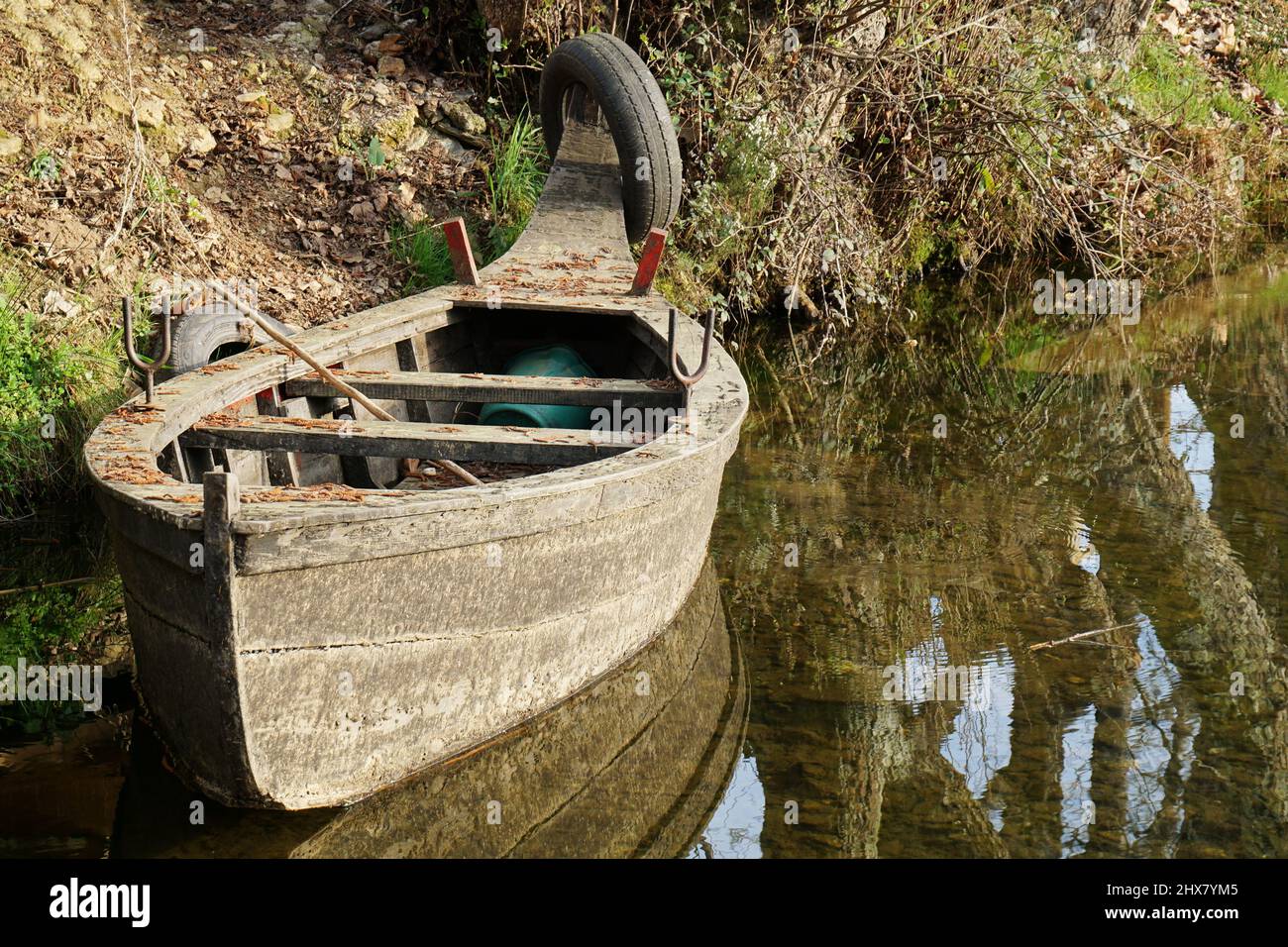 Rustic wooden boat anchored on the river Stock Photo - Alamy