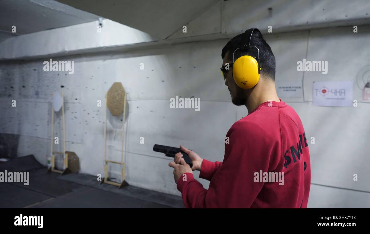 Man trains shooting at shooting range. Man shooting with air gun on ...