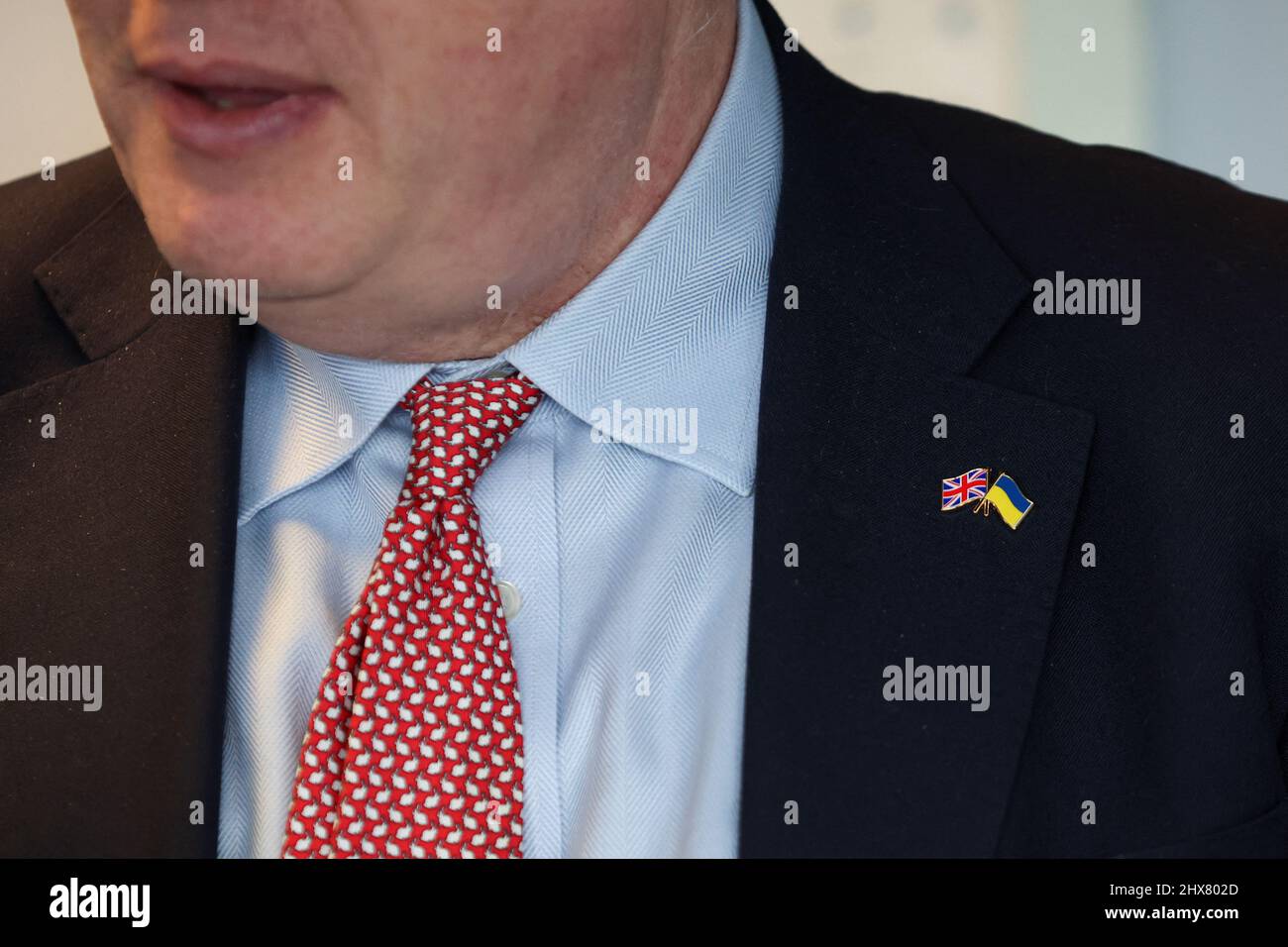 Prime Minister Boris Johnson wears a badge with the Union Jack and ...