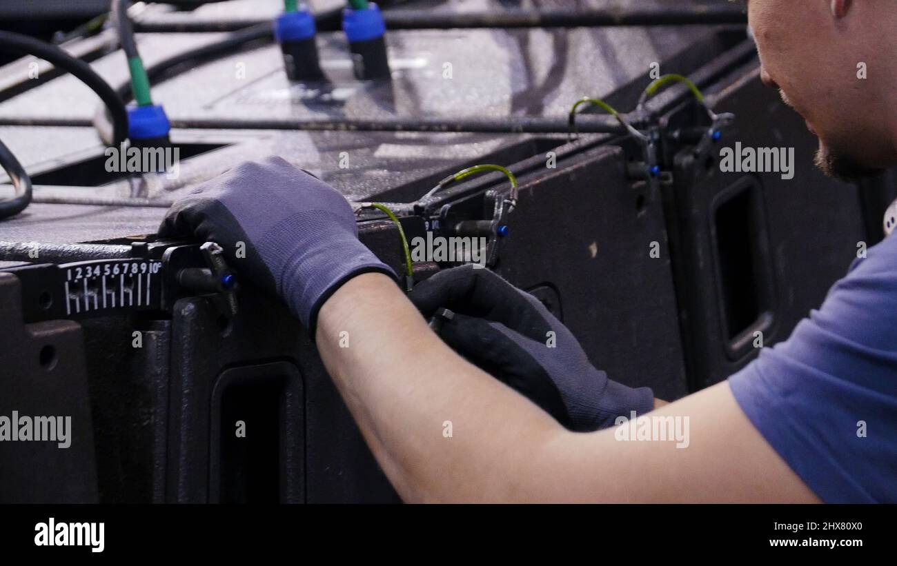 Lighting technicians intstalling professional lighting equipment. Man ...