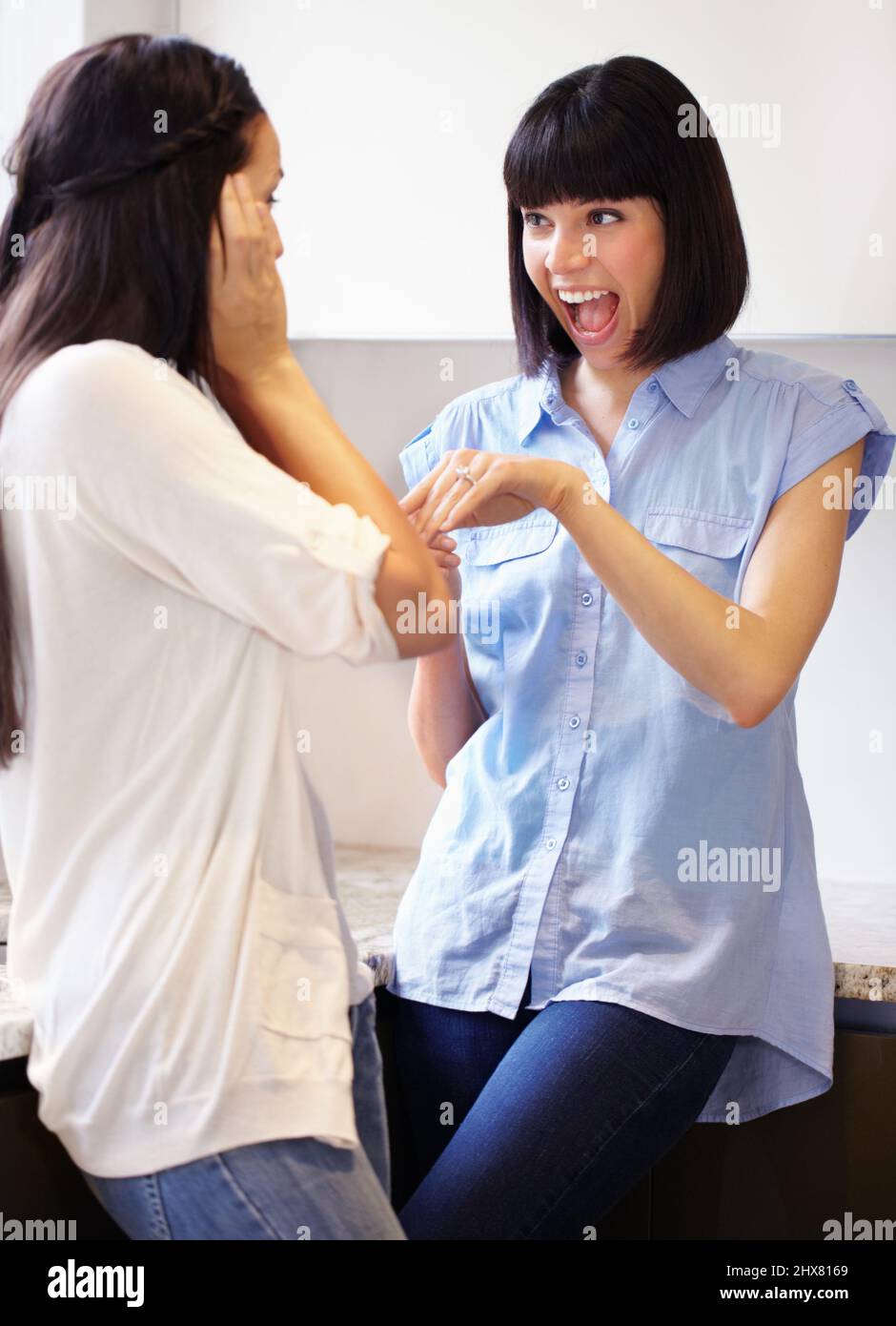 I said yes. An excited young woman showing her engagement ring to her ...