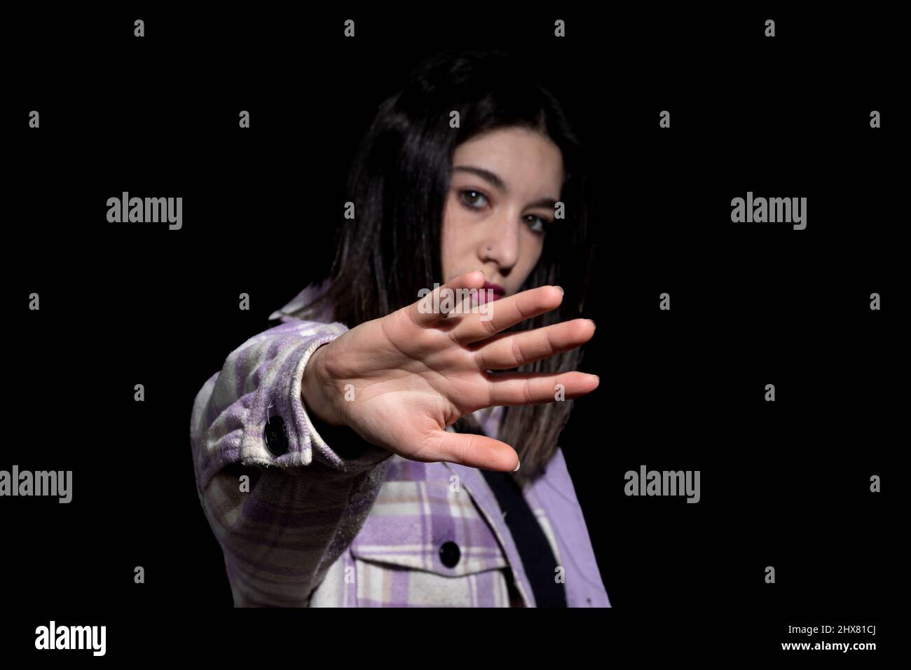 woman on black background ordering stop Stock Photo - Alamy