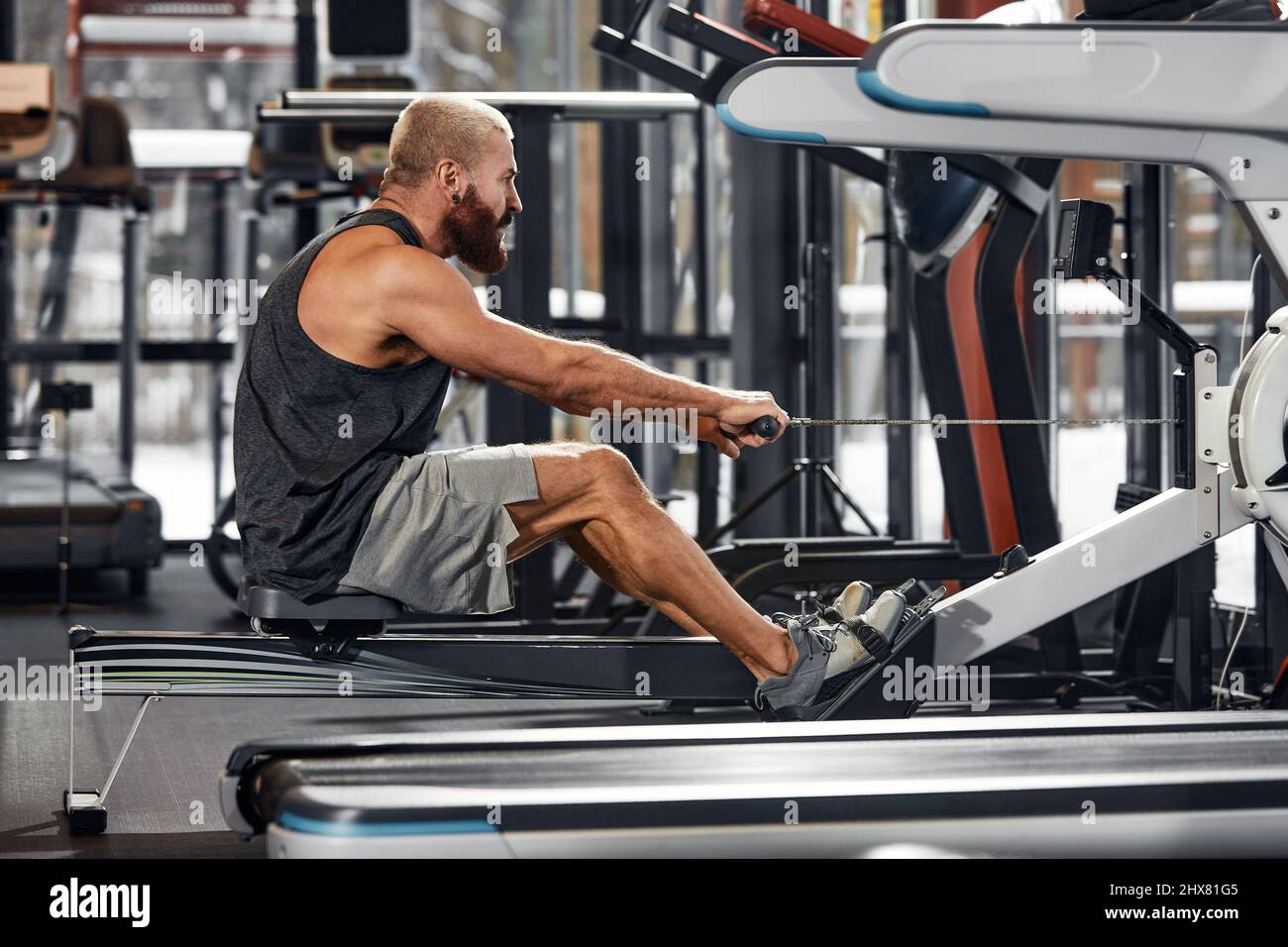 Training legs in the simulator, the athlete works with his legs on the ...