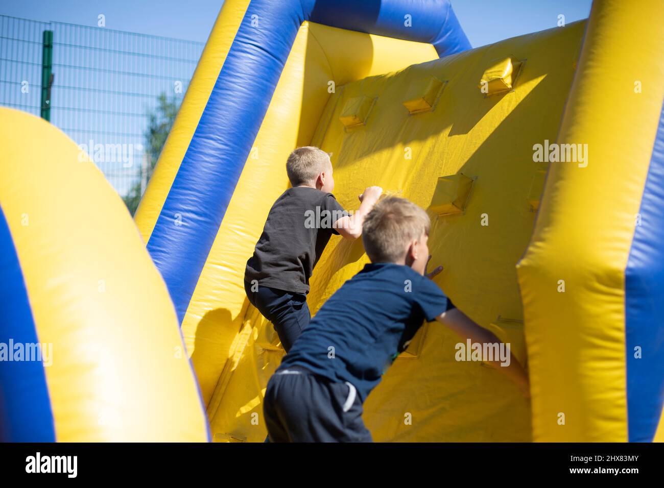 A child climbs an inflatable slide. Obstacle course for children ...