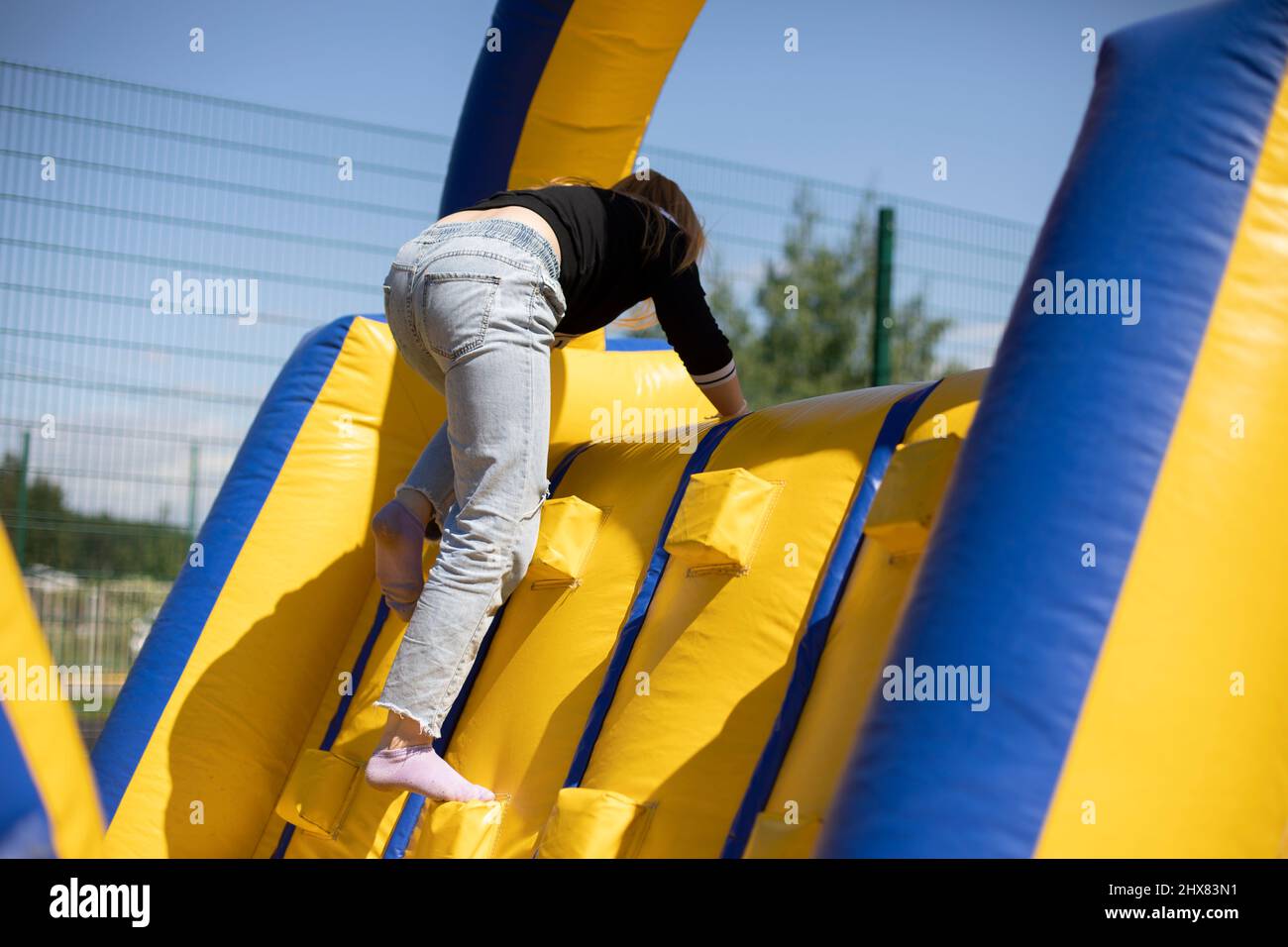 A child climbs an inflatable slide. Obstacle course for children ...