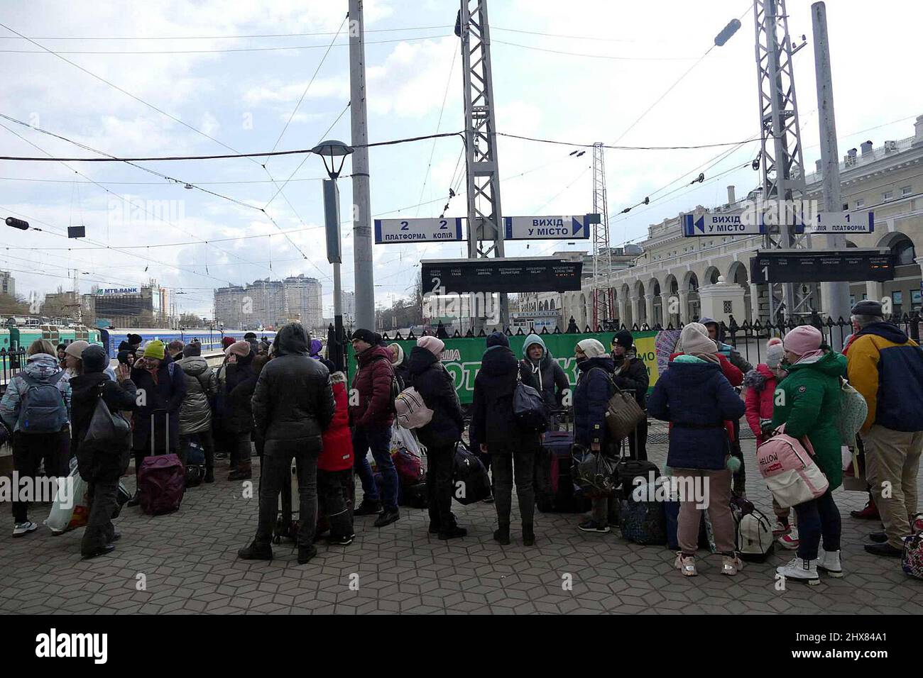 People stand in line to board the Odessa-Rakhiv evacuation train, Odesa ...