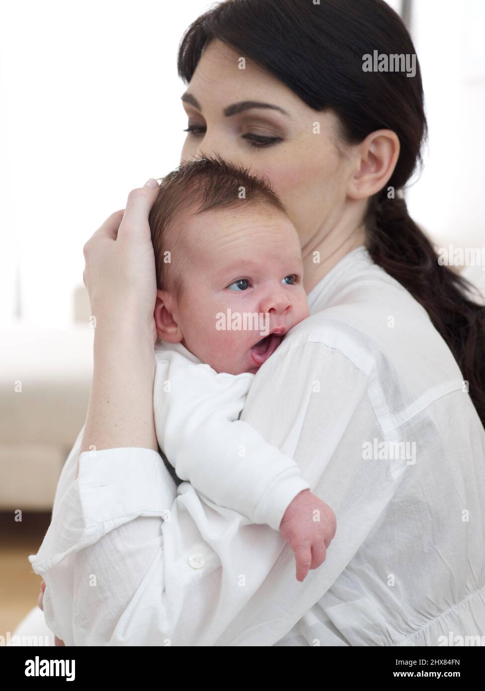 Woman hugging baby girl, 5 weeks Stock Photo - Alamy