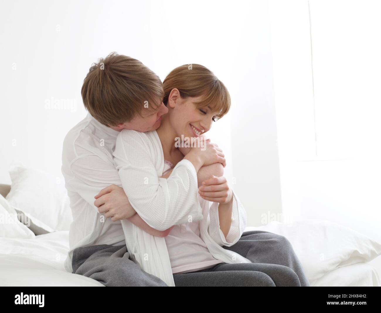 Blonde woman cuddling man hi-res stock photography and images - Alamy