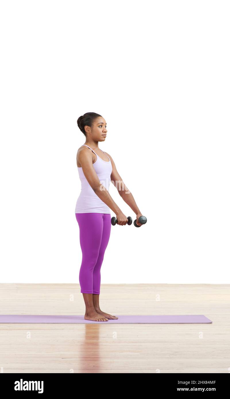 Woman practising Pilates side curls with dumbbells mat exercise, side ...