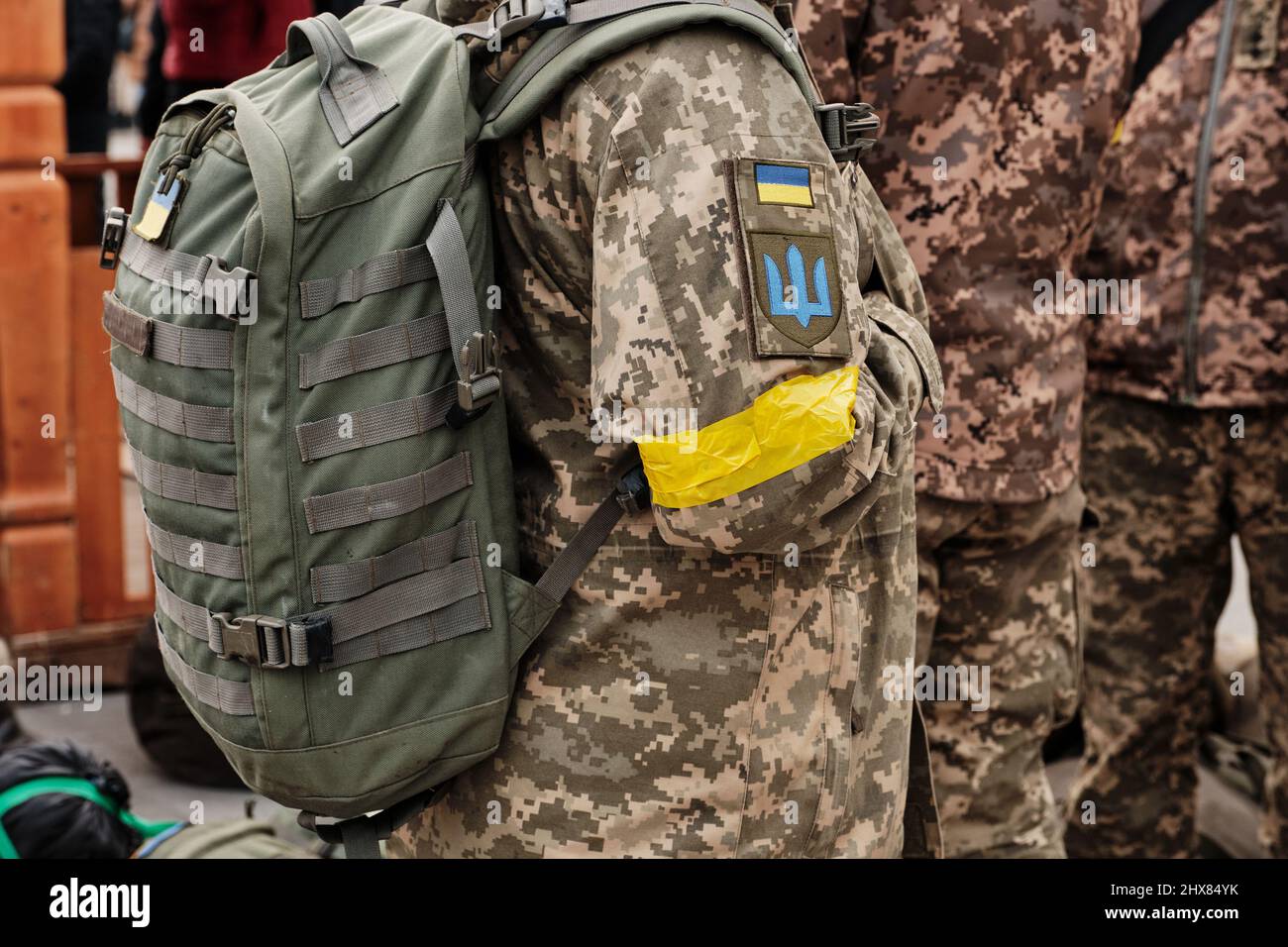 Ukrainian soldiers leave to join war effort. Ukrainian soldier wearing ...