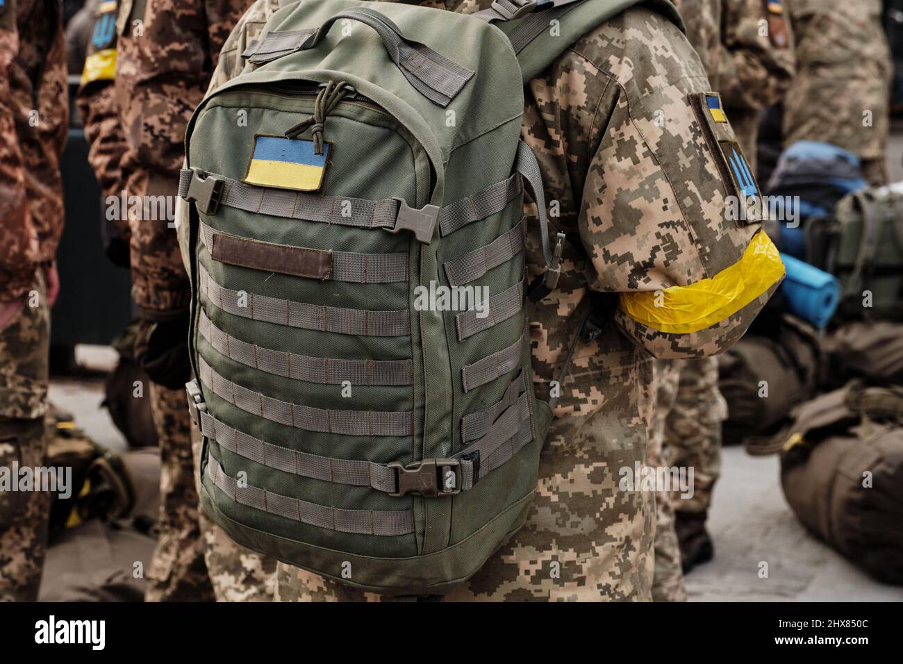 Ukrainian soldiers leave to join war effort. Ukrainian soldier wearing ...