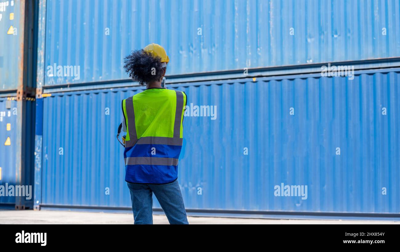Black woman facing back in front of the container Stock Photo - Alamy