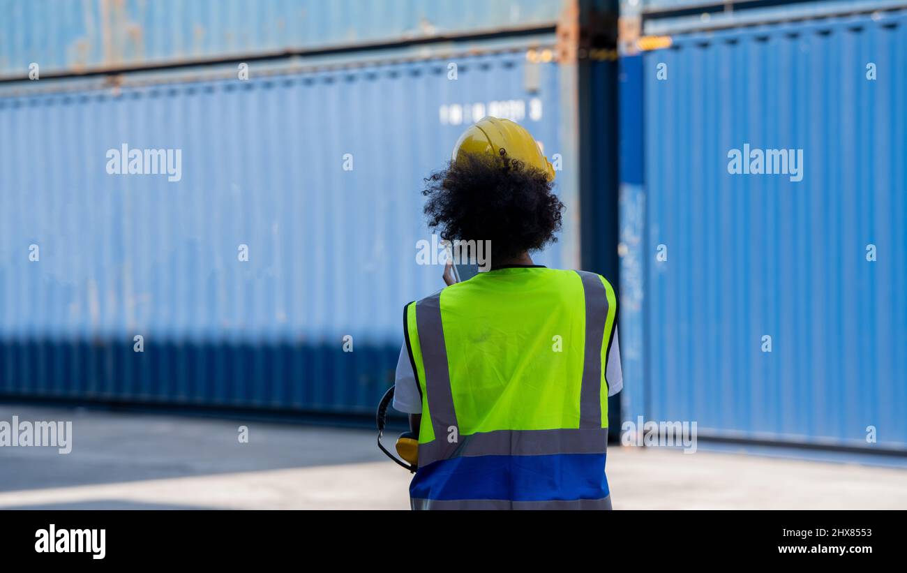 Black woman facing back in front of the container Stock Photo - Alamy