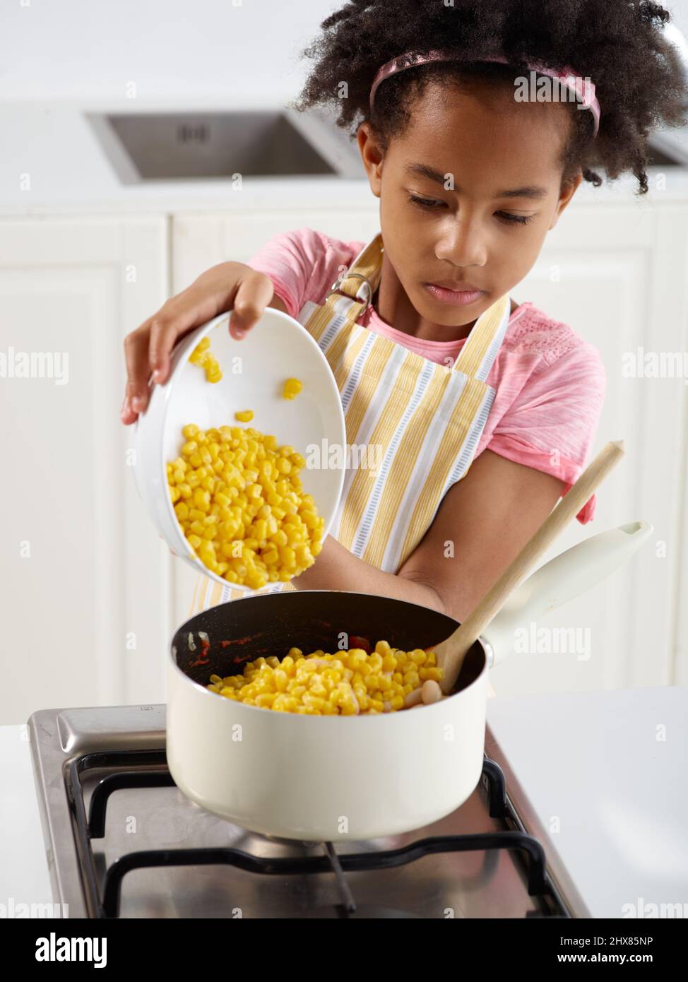 Bean and Corn Bake - Adding corn, beans, and tomatoes to a pan (Step 2 ...