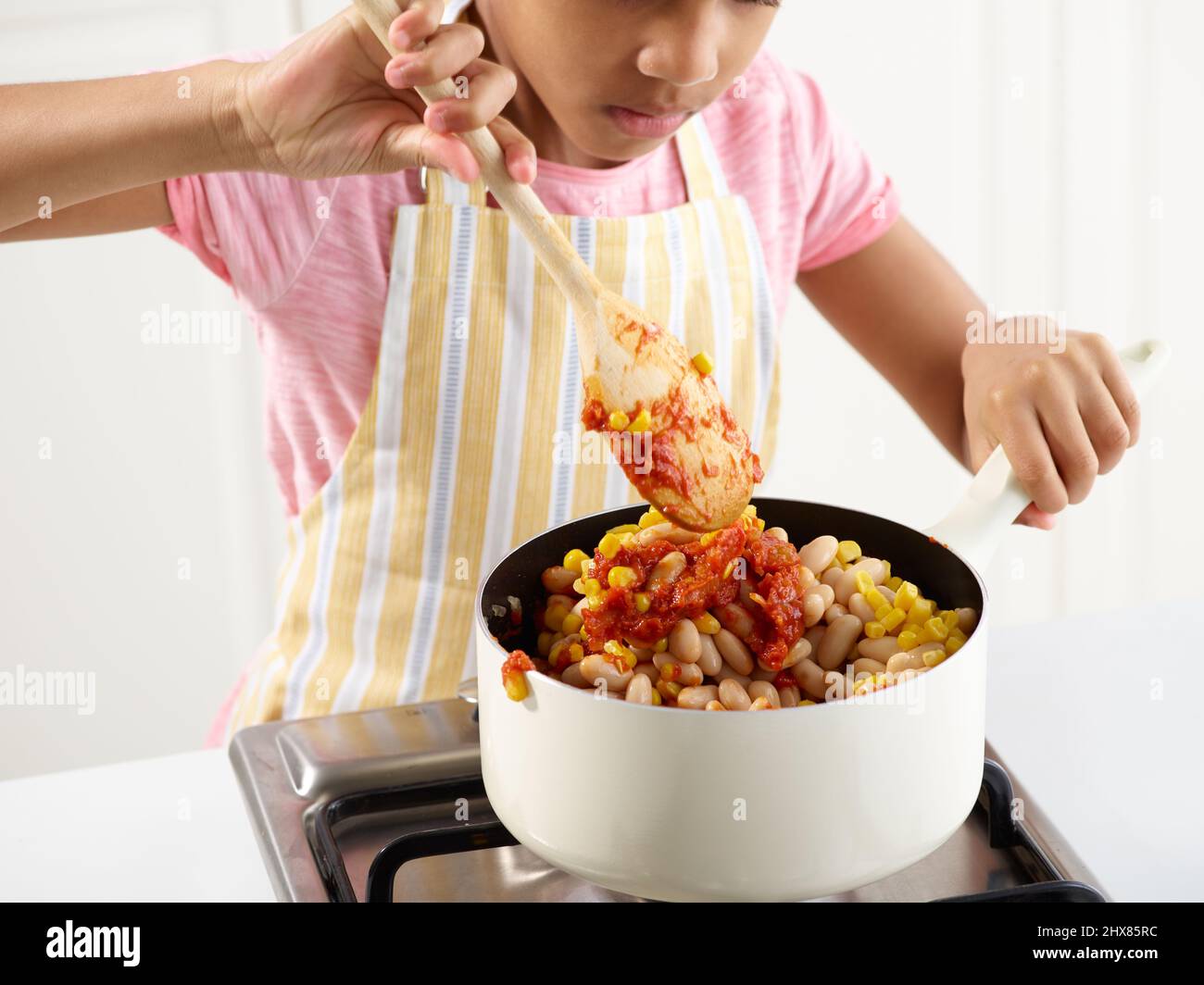 Bean and Corn Bake - Adding corn, beans, and tomatoes to a pan (Step 2 ...