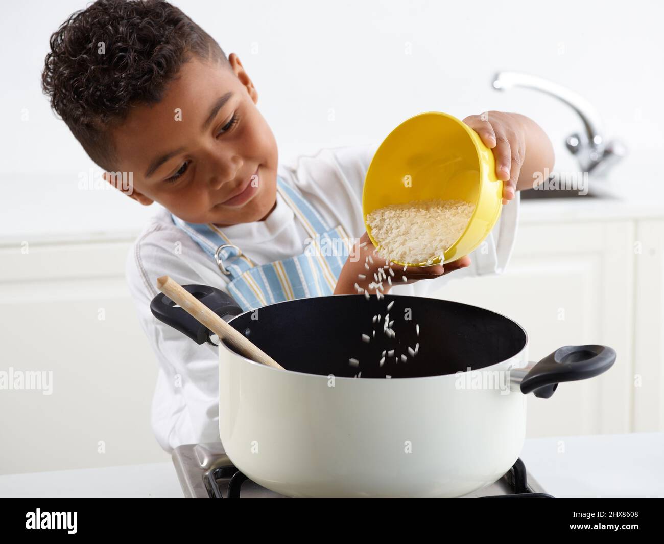 Veggie Jambalaya - Adding rice to a pan (Step 2 of 5 Stock Photo - Alamy